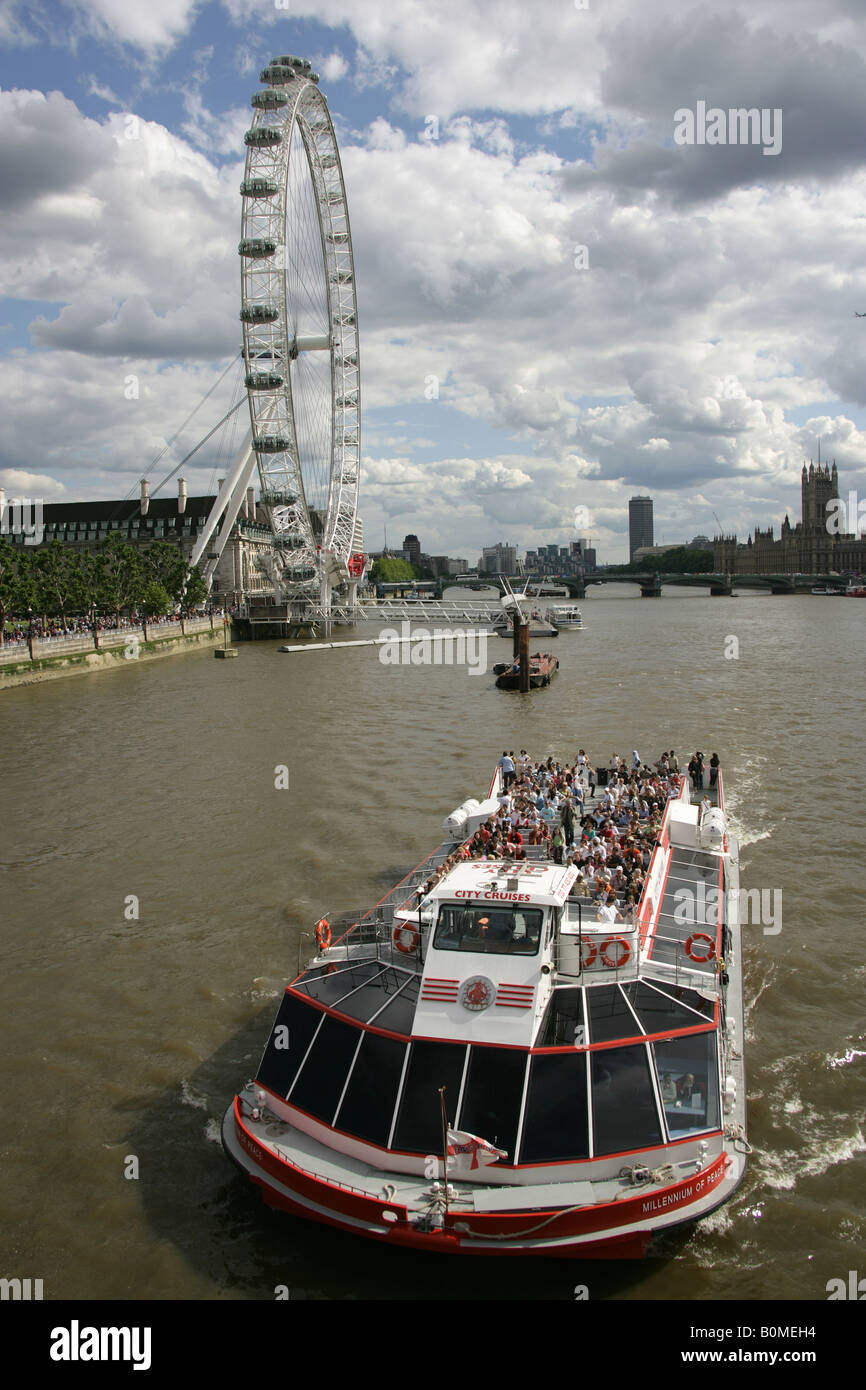 River Thames tourist cruise boat with London Eye (Millennium Wheel ...