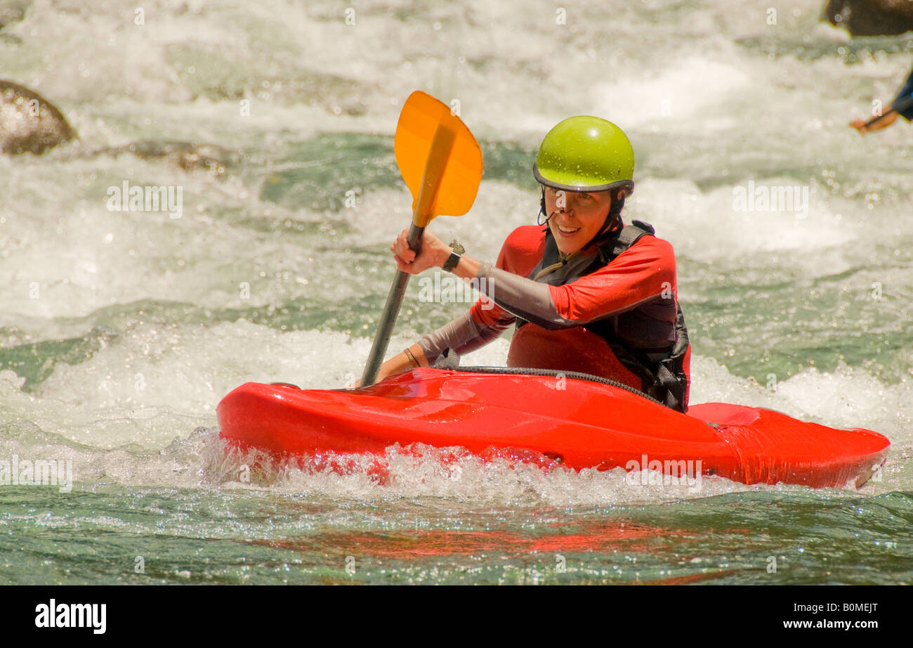 COSTA RICA Woman kayaking through whitewater on the Lower Pacuare River ...