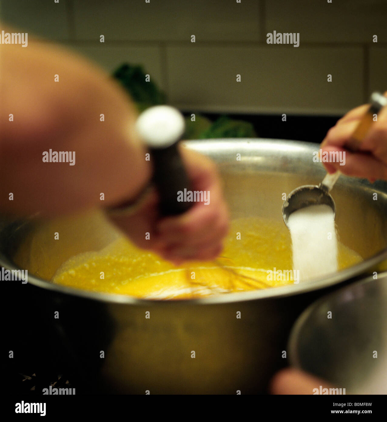 sugar being poured into a custard mix Stock Photo - Alamy