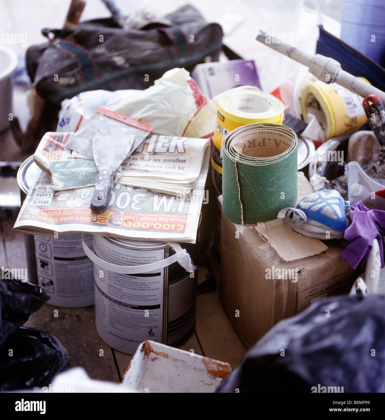 a builders mess in a house with a tabloid newspaper Stock Photo - Alamy