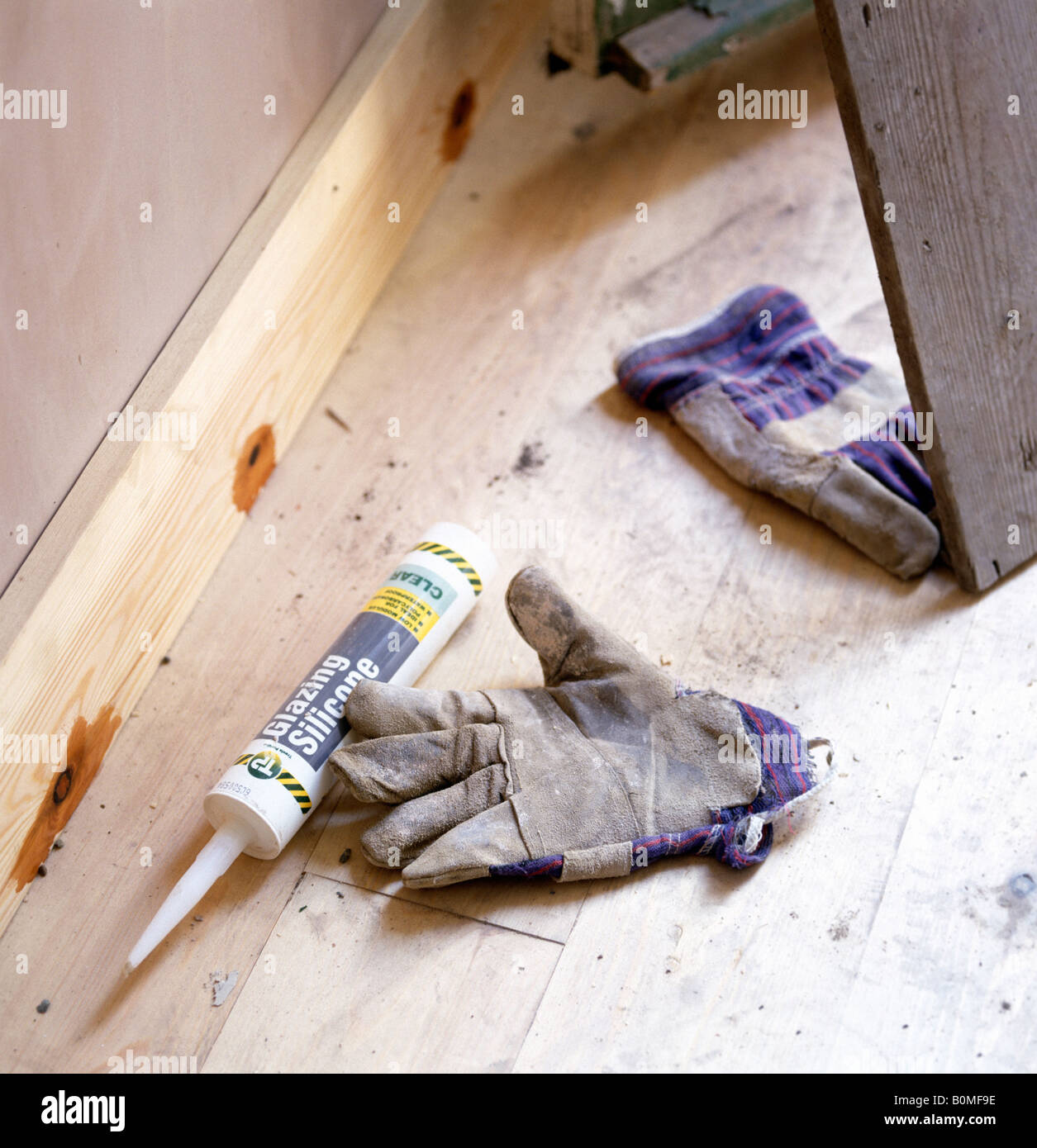 builders gloves and glazing silicone tube Stock Photo - Alamy