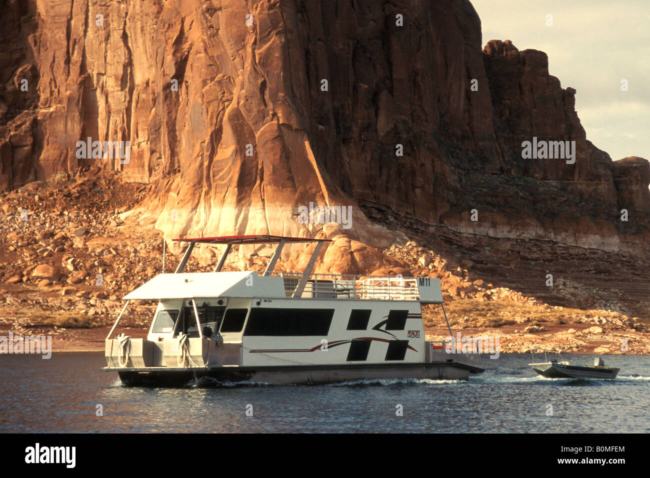 Houseboat tows a motorboat, Lake Powell, Glen Canyon National ...