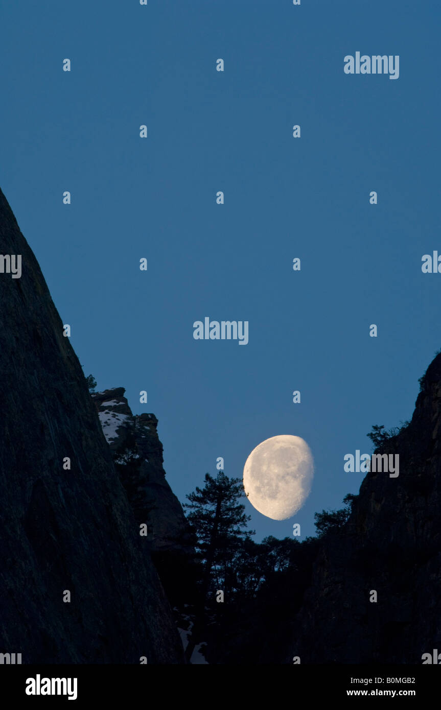 Waning gibbous moon setting behind mountain cliff Yosemite National ...