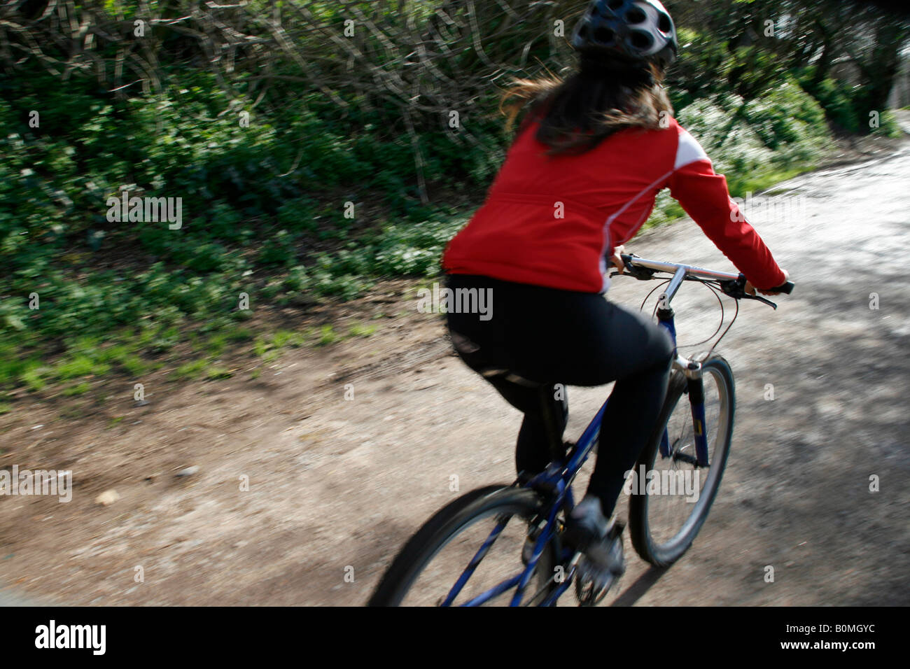 woman riding bike in countryside Stock Photo - Alamy
