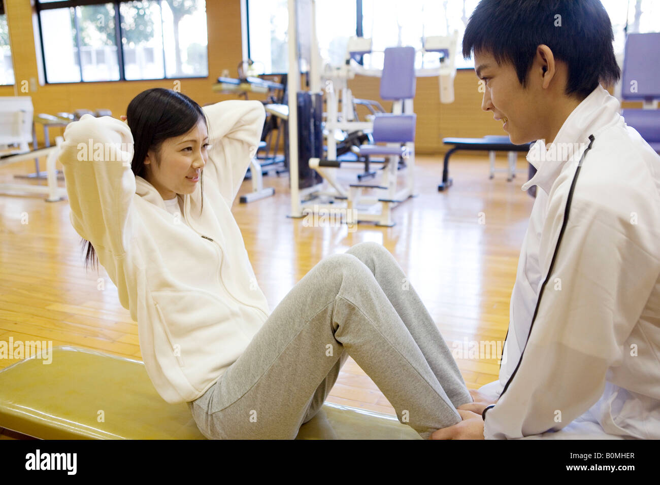 Japanese young woman training in a gym Stock Photo - Alamy