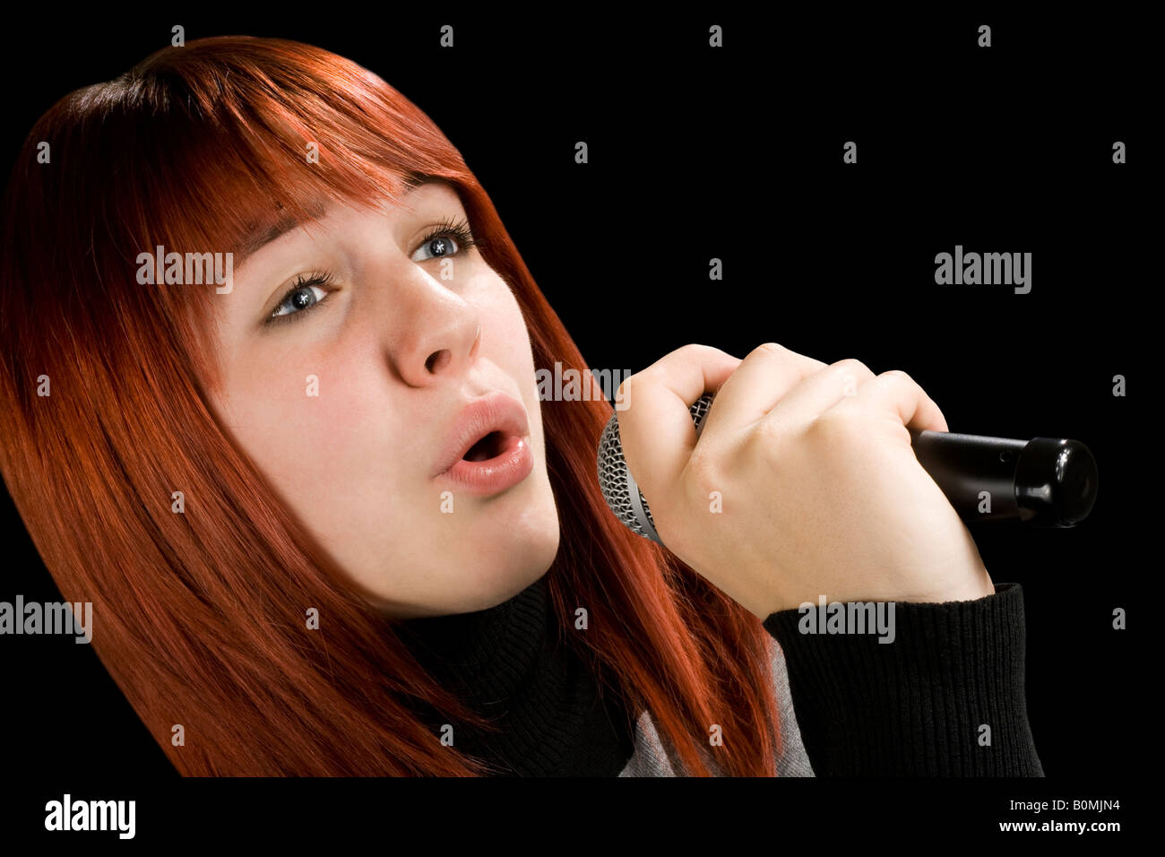 Girl using microphone beautiful redhead with blue eyes Studio shot ...