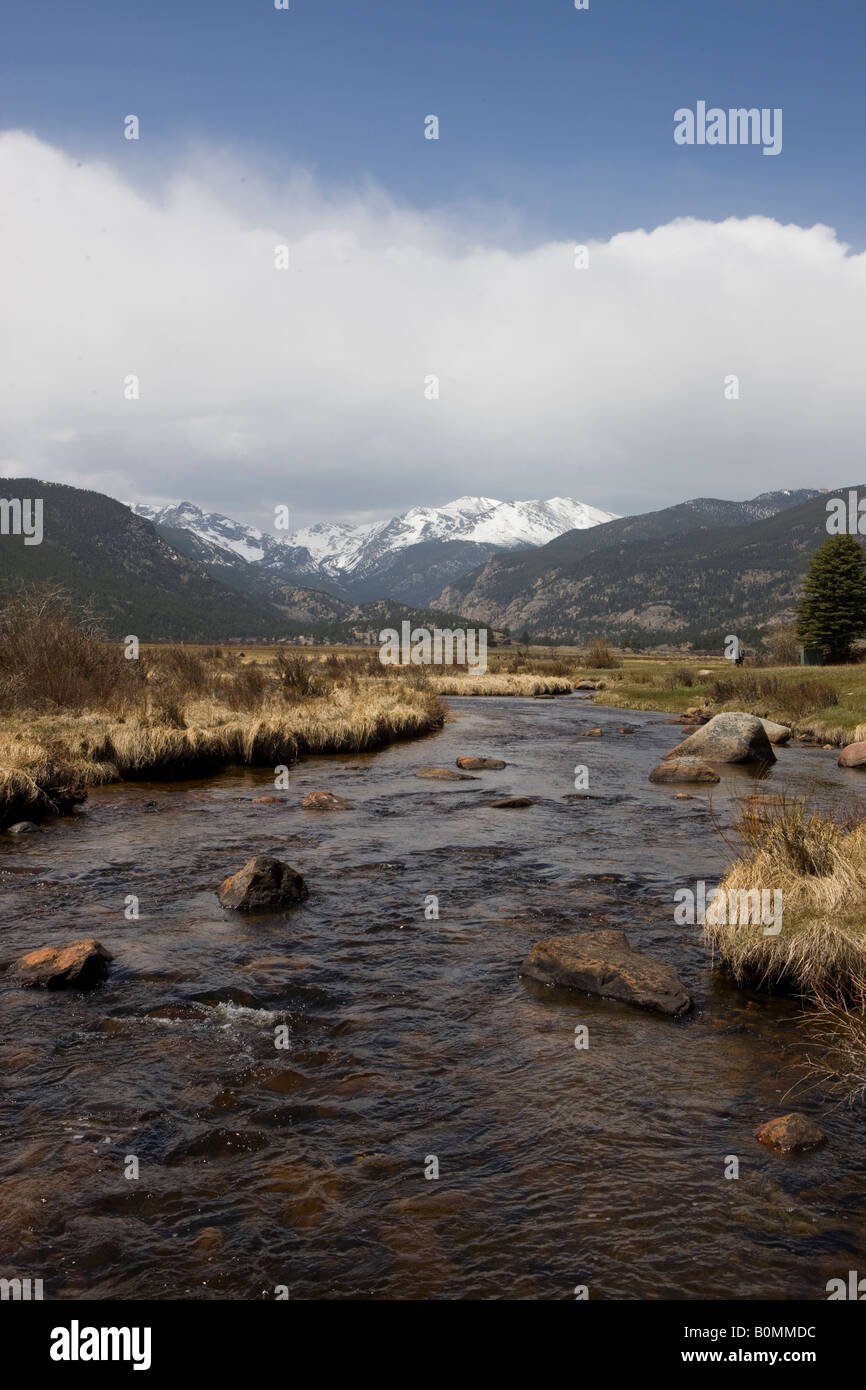 Swift moving stream flows through Moraine Park with snow capped Rockies ...