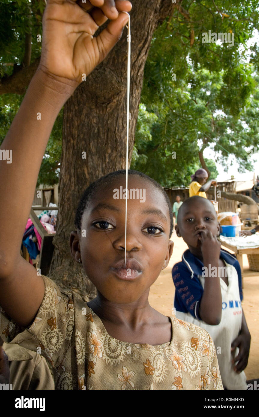 Girl pulling chewing gum, Kuluedor, Ghana Stock Photo - Alamy