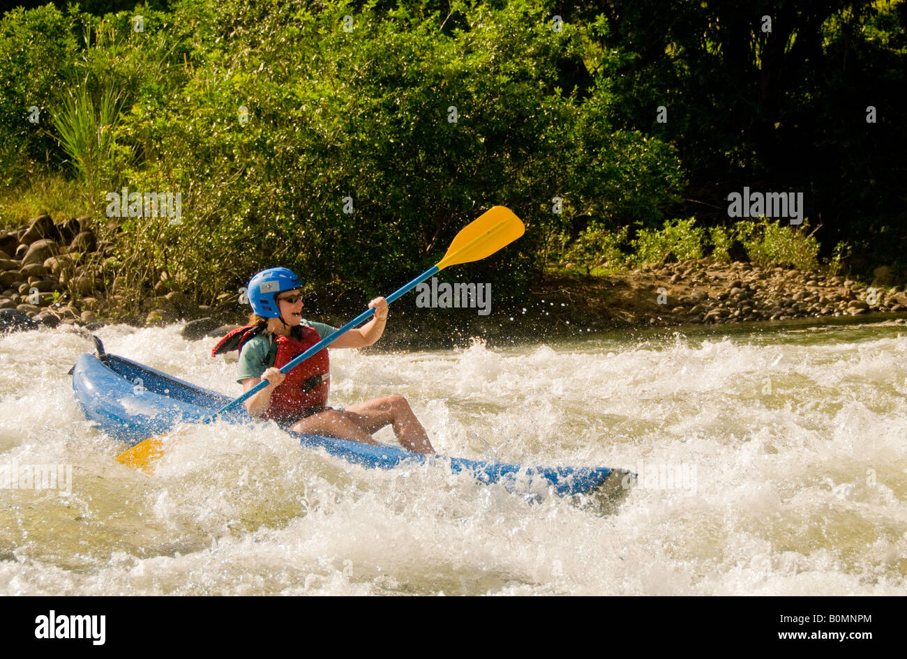 COSTA RICA Woman whitewater kayaking on the Lower Pacuare River ...