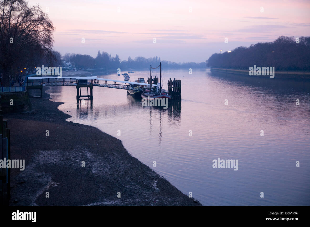 View of the Thames and masted boat moored to a jetty, on the Thames at ...