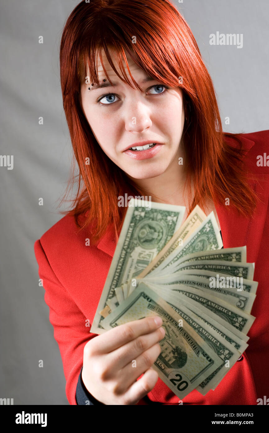 Surprised girl waving American banknotes dollars Studio shot Stock ...