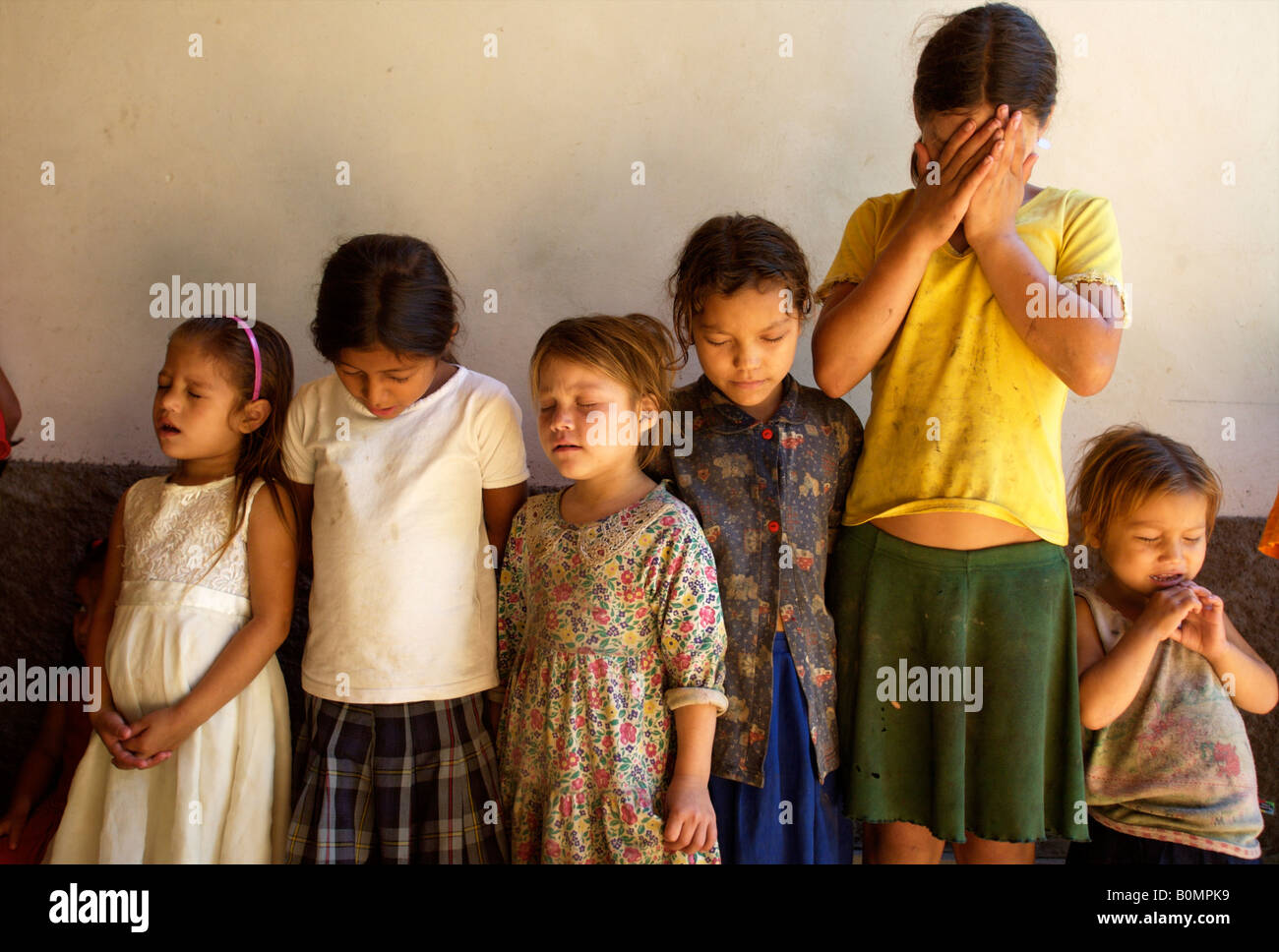 Children pray while attending Sunday school put on by baptist ...