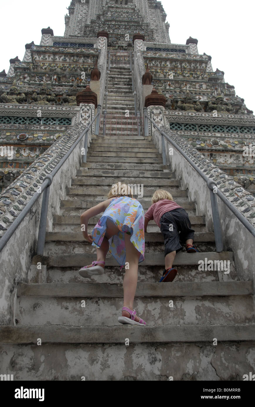 Lucy and Wilf clambering up the steps of Wat Arun, Bangkok, Thailand ...