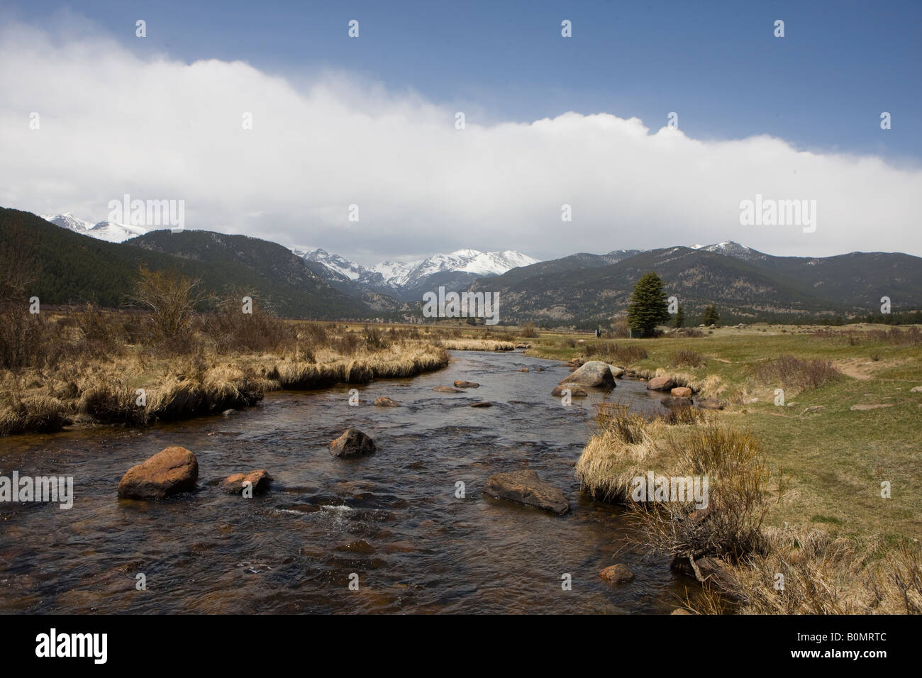 Swift moving stream flows through Moraine Park with snow capped Rockies ...