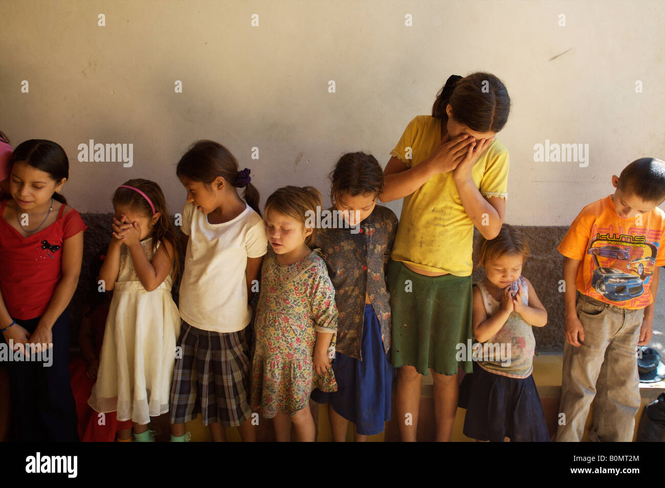 Children pray while attending Sunday school put on by baptist ...