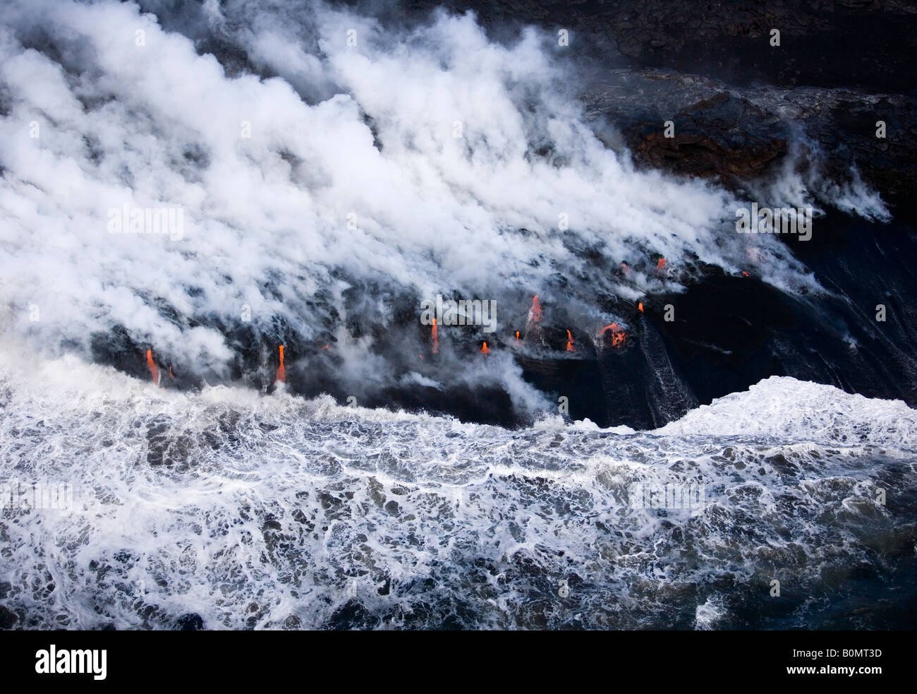 Steaming coastal lava flow from Kilauea Volcano eruption ocean waves ...