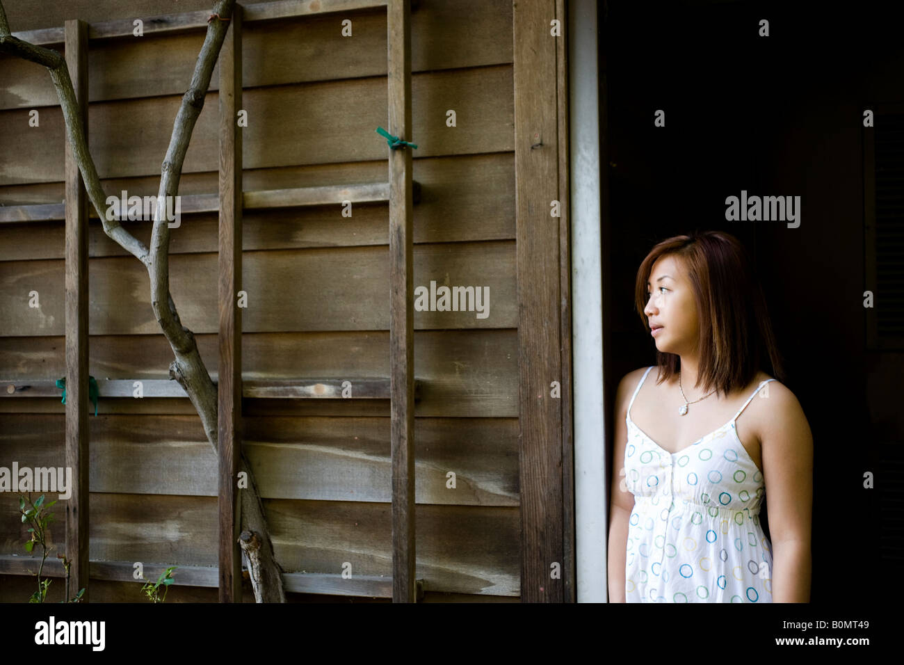 Woman peeking around corner hi-res stock photography and images - Alamy