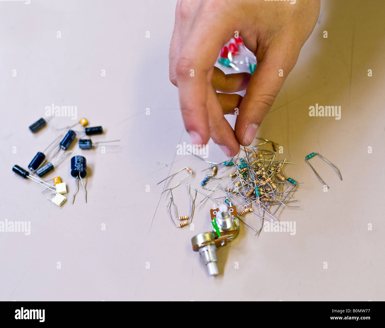 A hand sorting out electronic components Stock Photo - Alamy