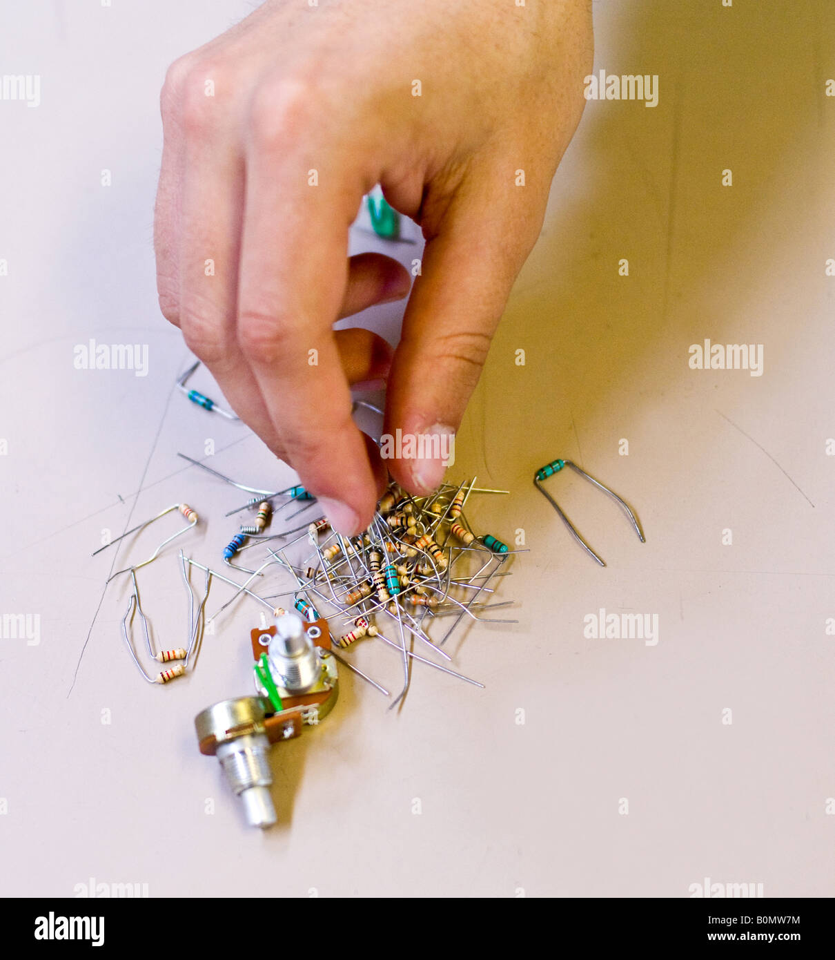 A hand sorting out electronic components Stock Photo - Alamy