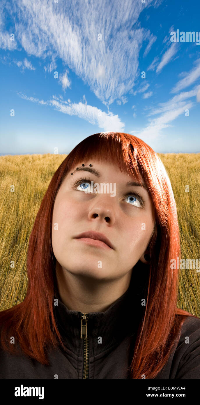Girl filled with hope and optimism staring at the blue sky Stock Photo ...