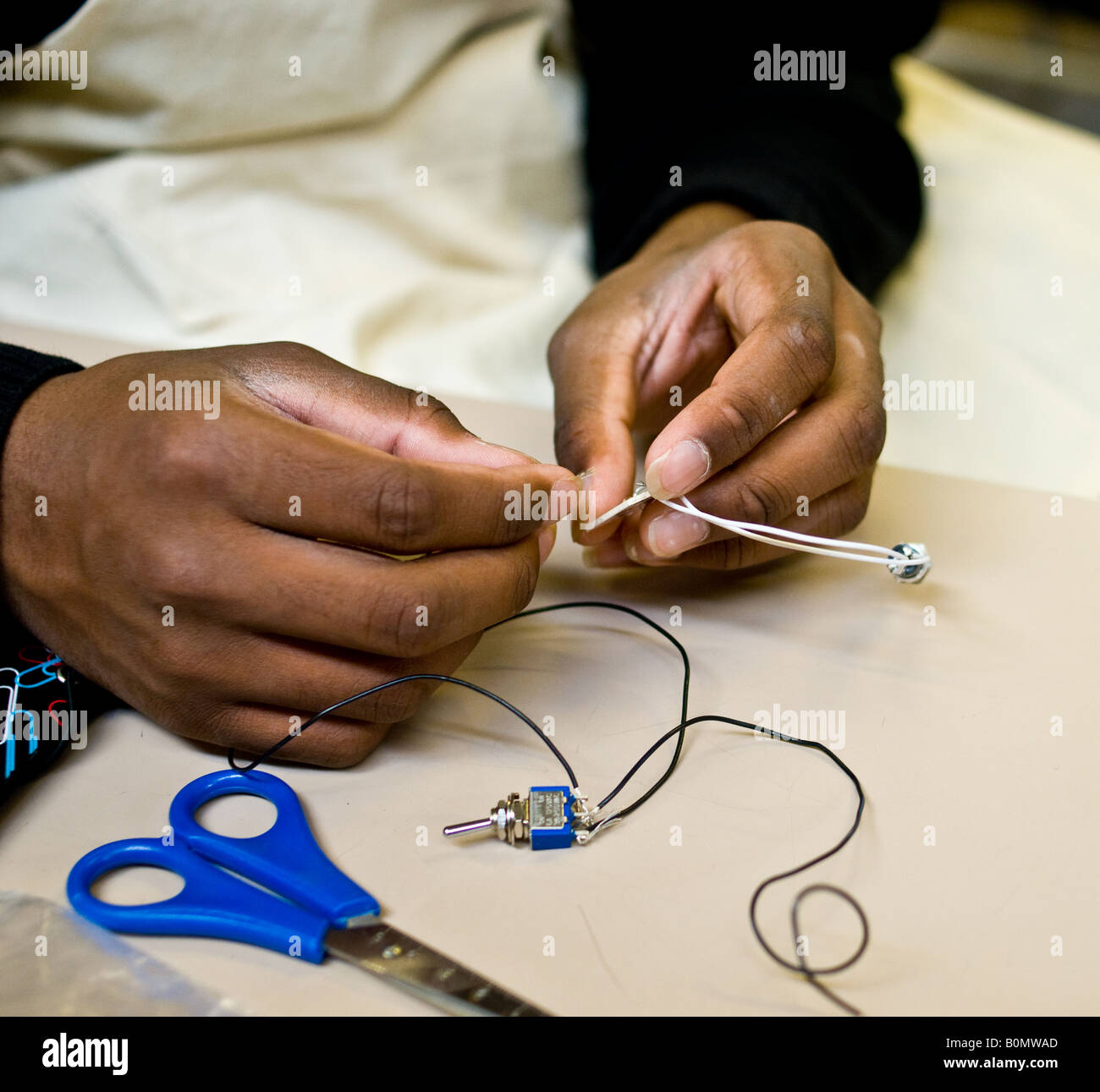 Education - A student working in a school practical electronics lesson ...