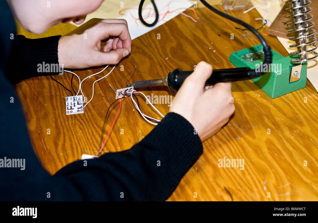 Education - A student working in an school electronics class Stock ...