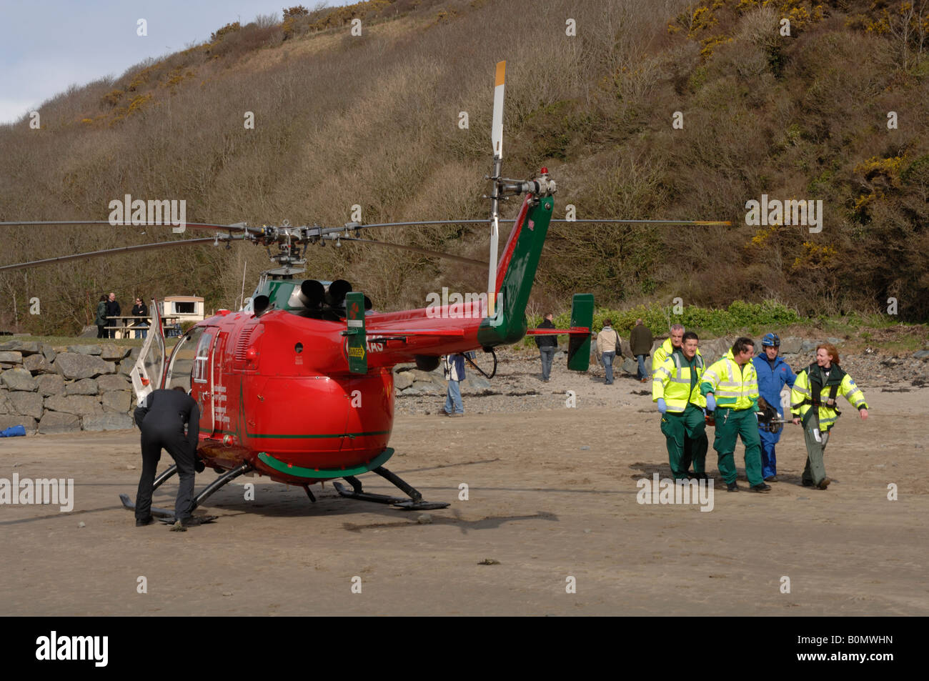 Wales Air Ambulance helicopter and crew rescuing a casualty at Solva ...