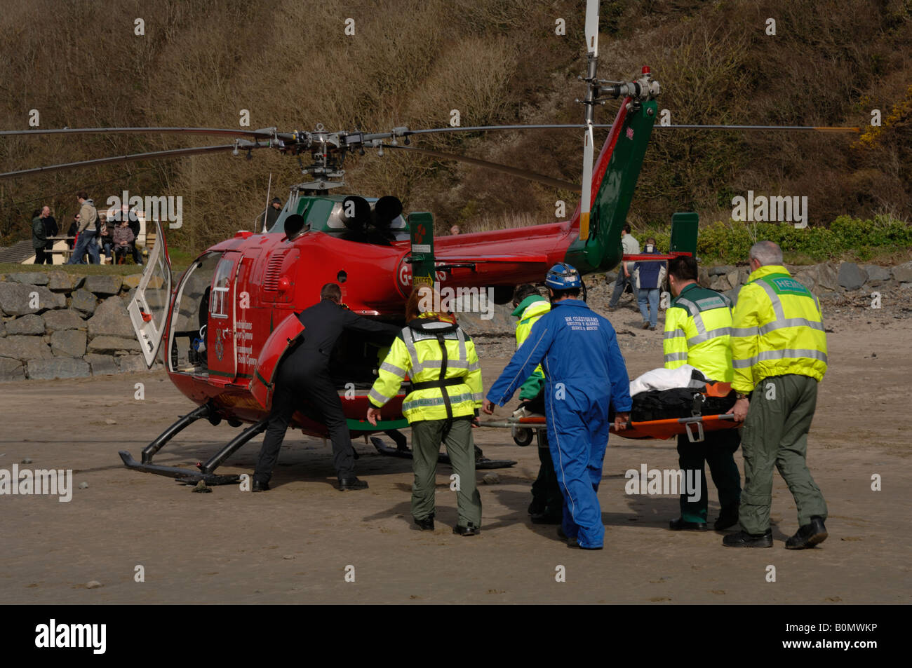 Wales Air Ambulance helicopter and crew rescuing a casualty at Solva ...