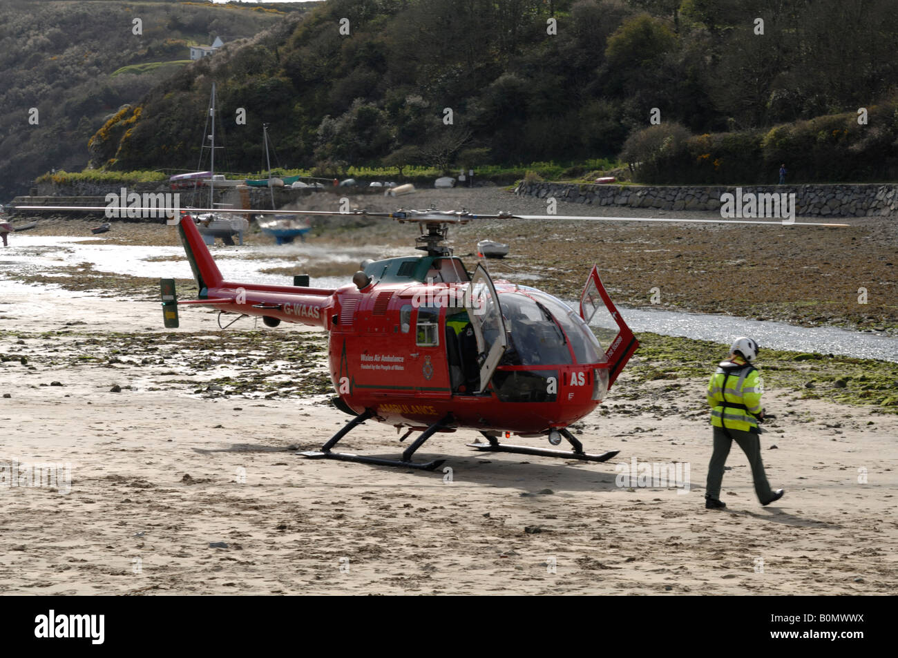 Wales Air Ambulance helicopter and crew rescuing a casualty at Solva ...