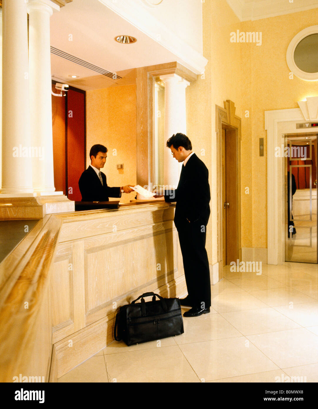 hotel reception, man checking out Stock Photo - Alamy hotel reception, man checking out Stock Photo - Alamy