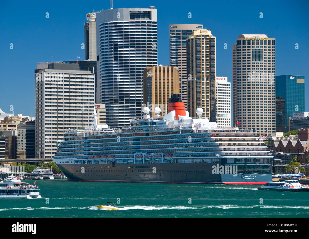 cunards queen victoria cruise ship in sydeny harbor with city skyline ...