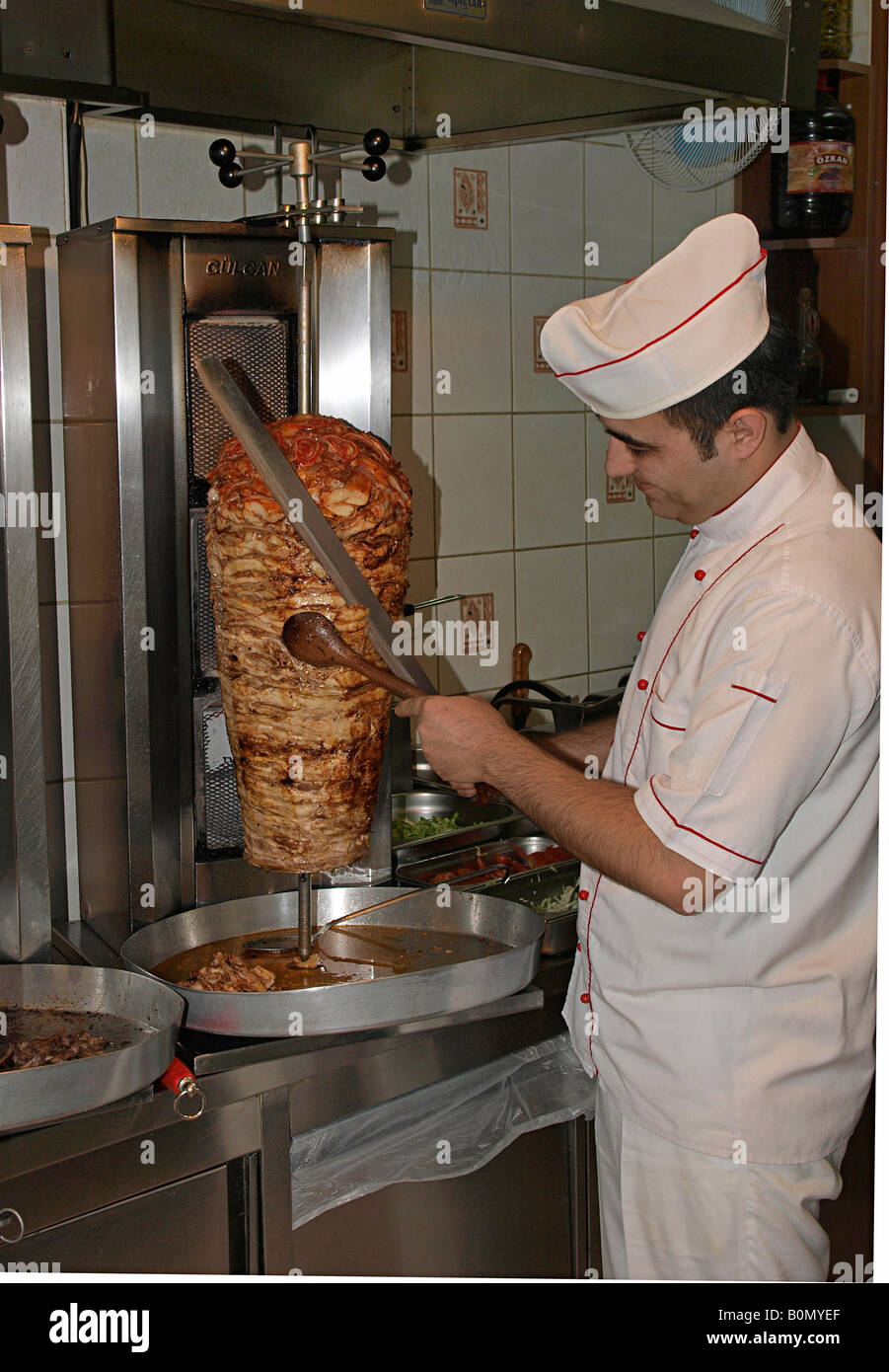 CARVING MEAT FOR KEBAB IN SMALL RESTAURANT IN MARMARIS MUGLA TURKEY ...