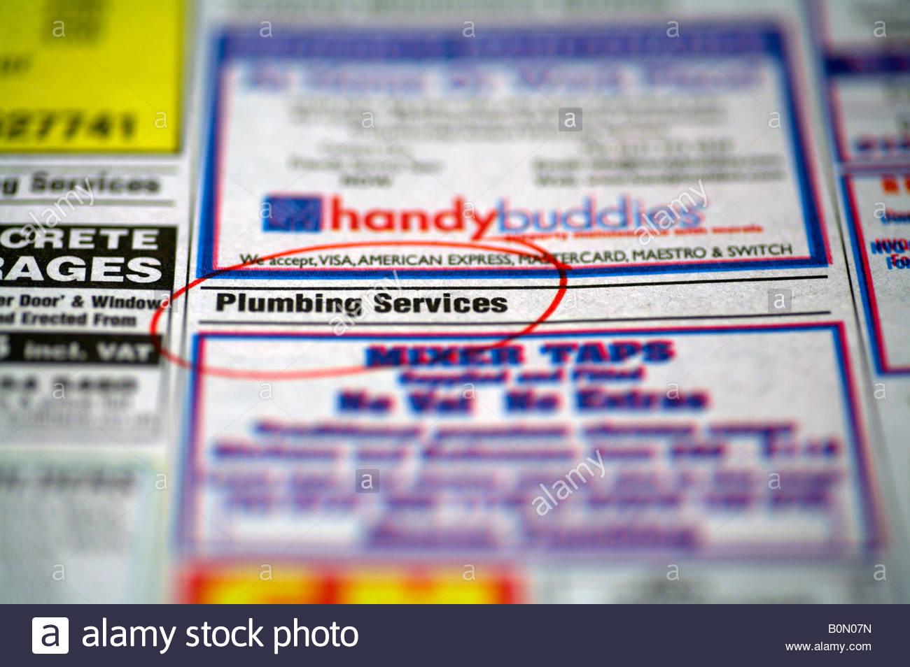 Plumbers small ad in newspaper classifieds Stock Photo - Alamy
