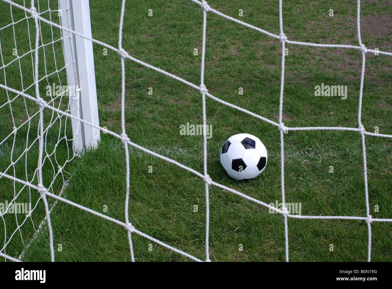 Soccer ball in the goal net Stock Photo - Alamy