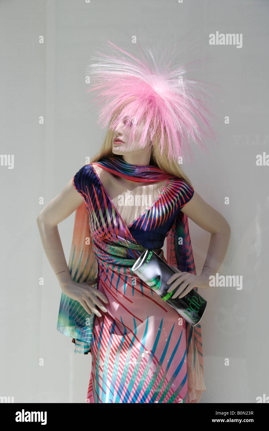 Female mannequin with pink spiky hair in colourful dress on display in ...