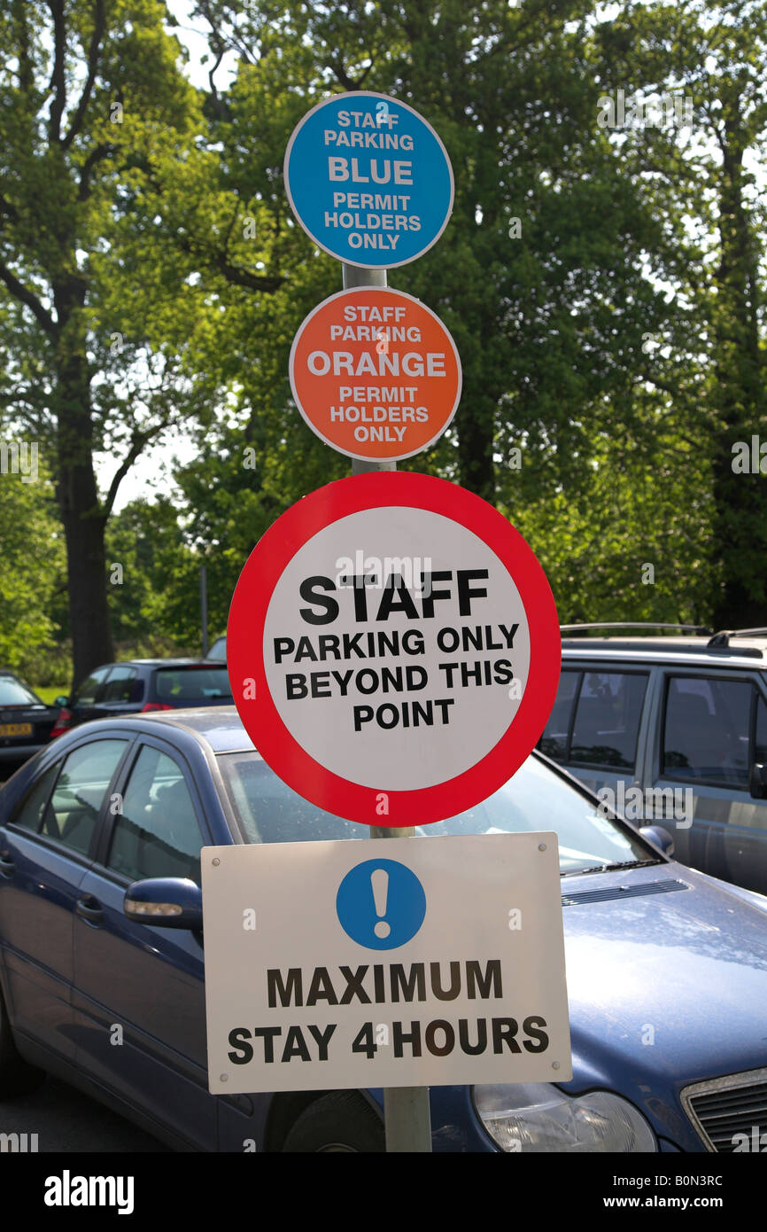 Authorised parking only signs displayed at entrance to a staff car park ...