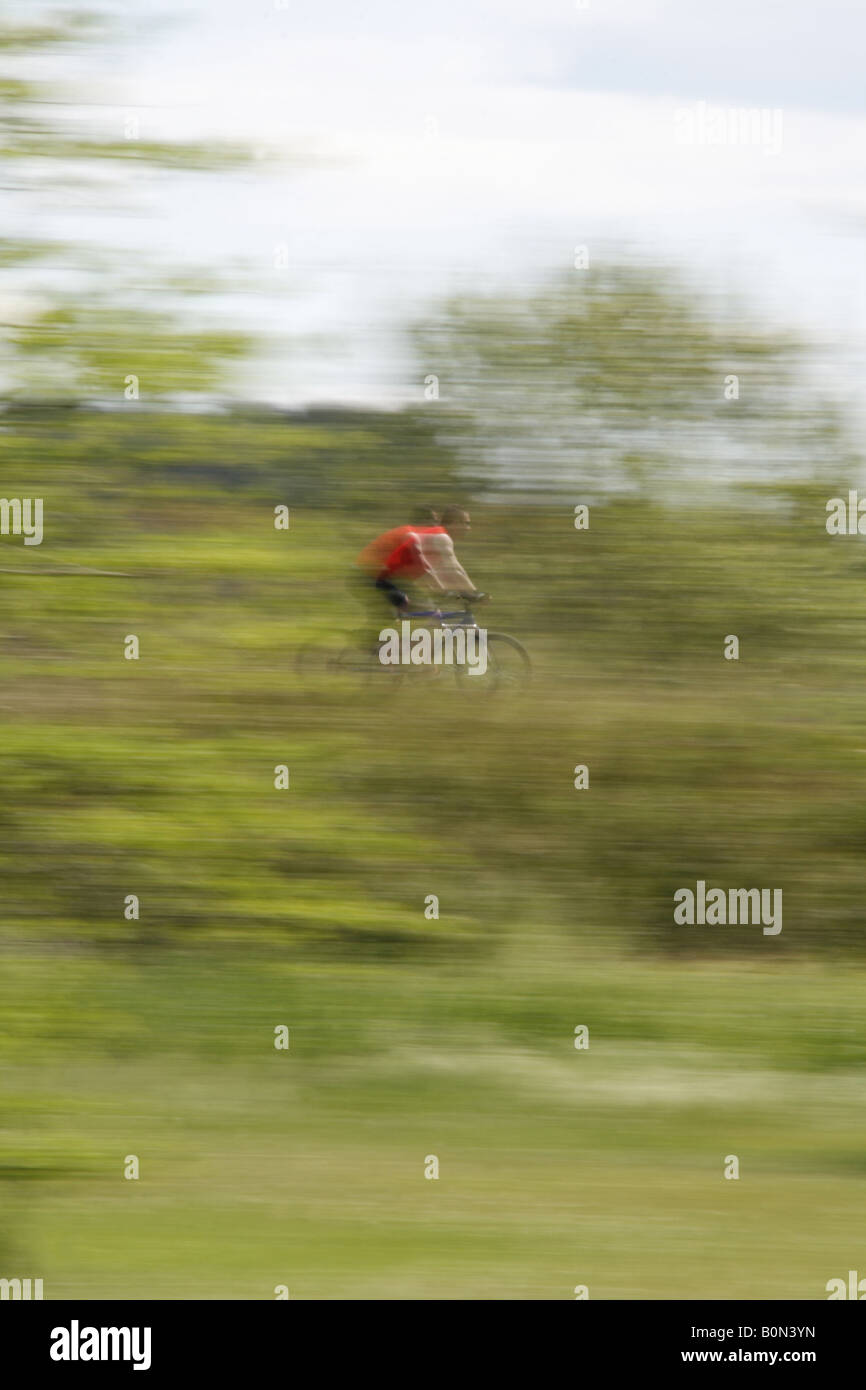 person riding fast bike in countryside Stock Photo - Alamy