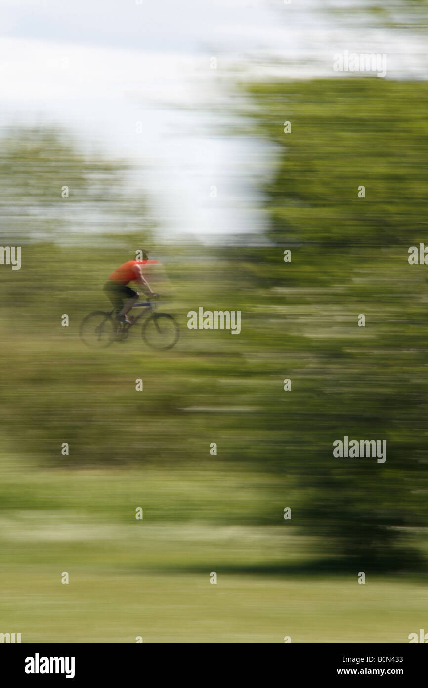person riding fast bike in countryside Stock Photo - Alamy