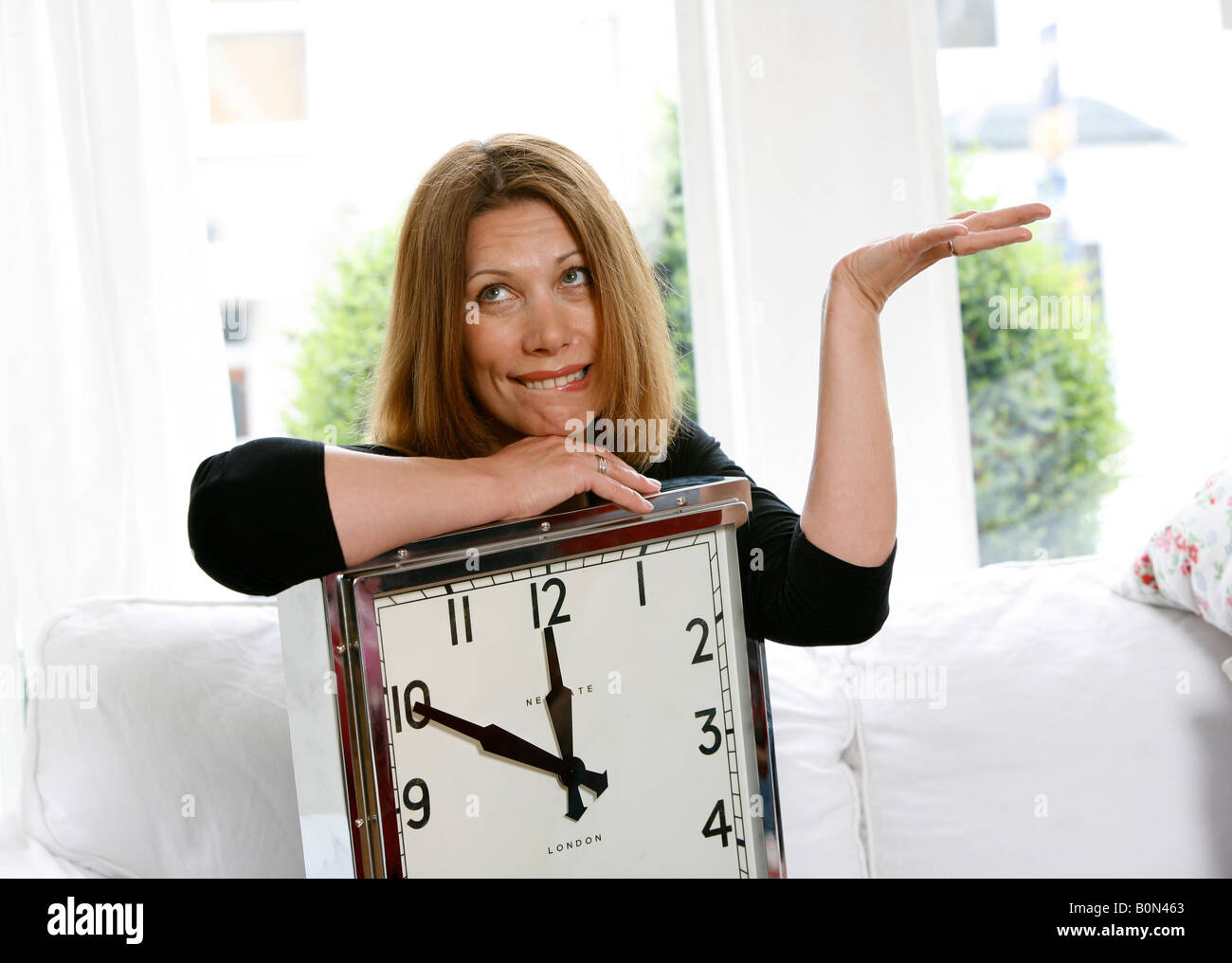 Running Late, woman runs late and is worried about the time, holding ...