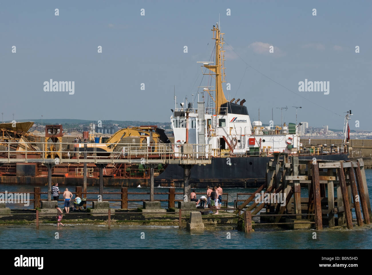 ship tanker entering port people watching harbour side Stock Photo - Alamy