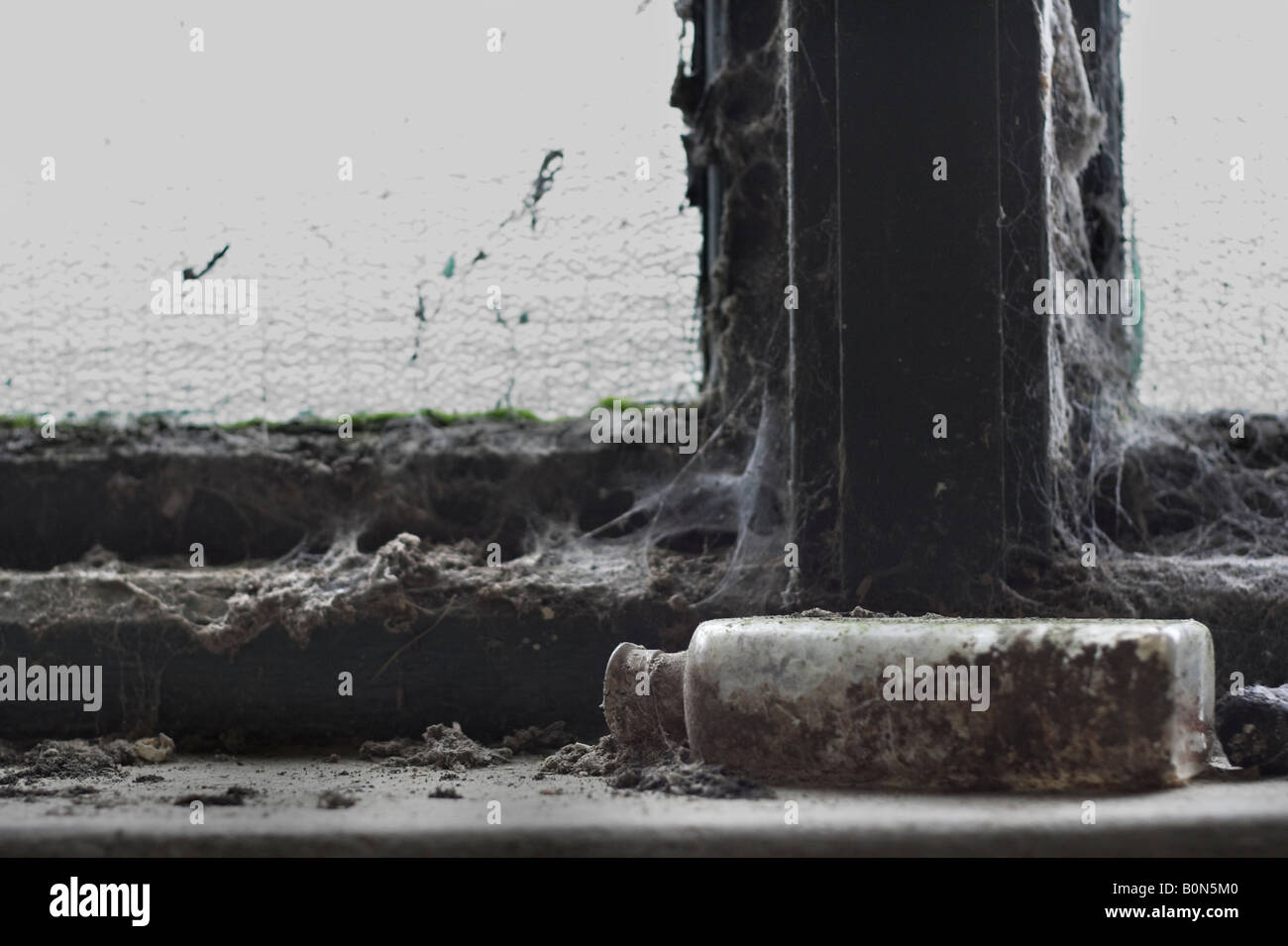 Dusty old medicine potion bottle on stone window ledge Stock Photo - Alamy