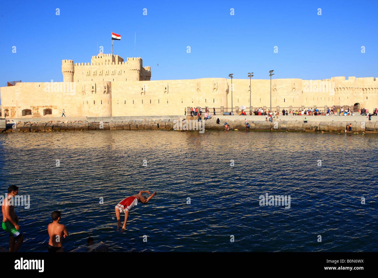They took a plunge into the sea with background the Qaitbey fort in ...