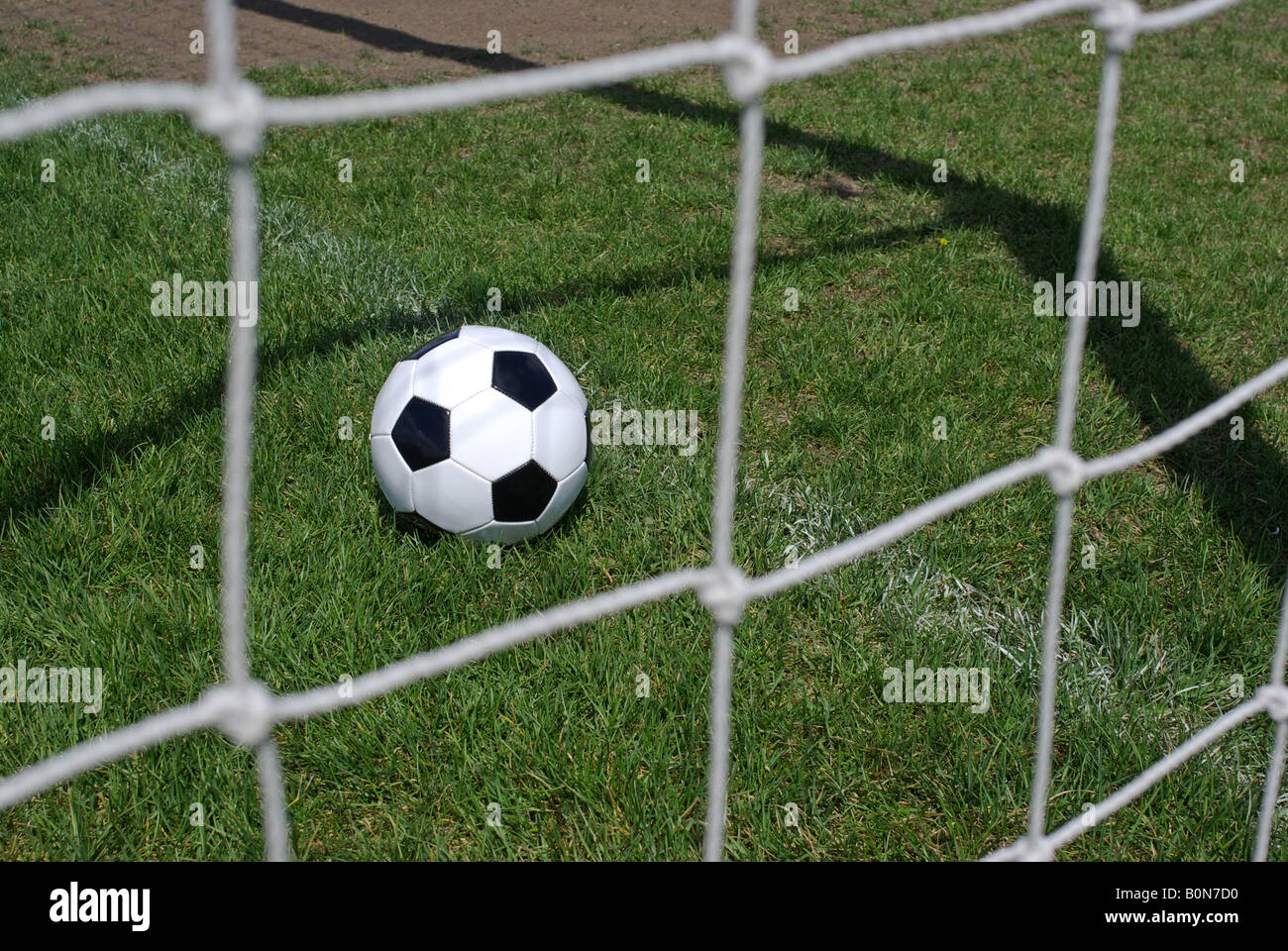 Soccer ball in the goal net Stock Photo - Alamy