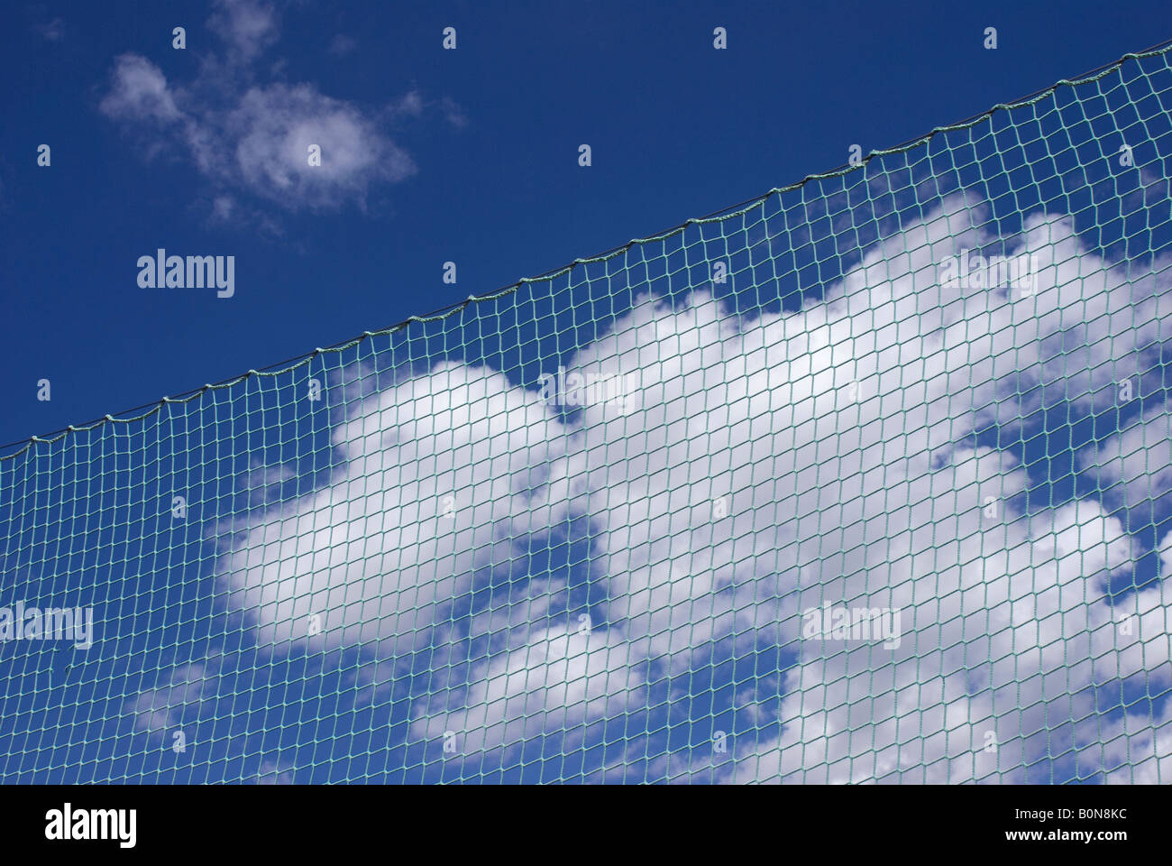 net against blue sky with white clouds Stock Photo - Alamy