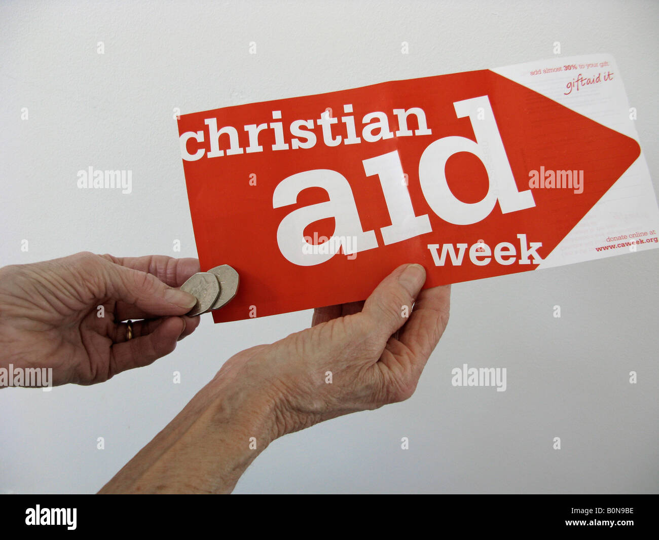 woman holding donation of coins for a charity collecting envelope for ...