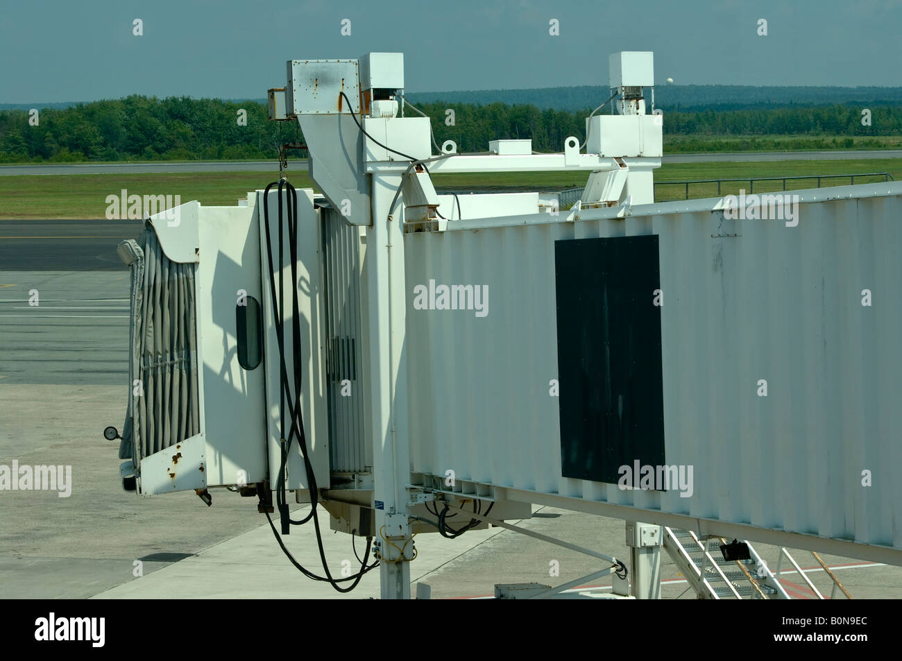 Passenger loading bridge extended from one of the gates ready to accept ...