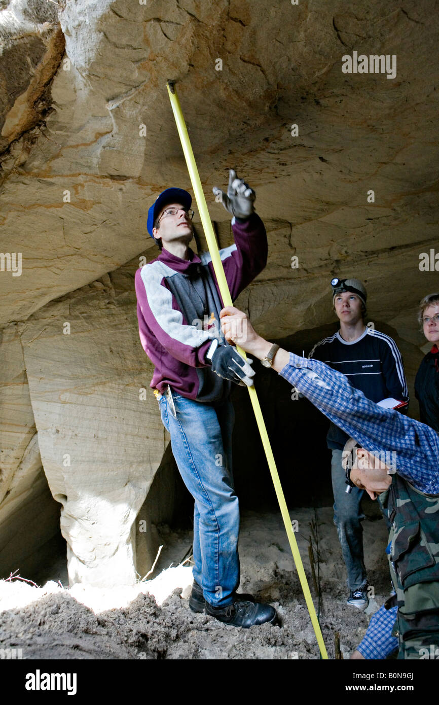 People measuring height while exploring cave at Vaidavas hillfort in ...
