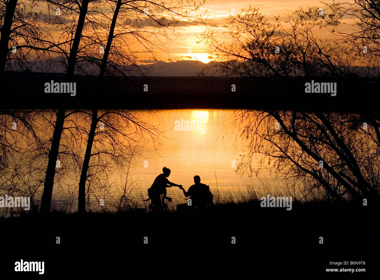 Nightfall sunset mountains lake family couple fishing hi-res stock ...