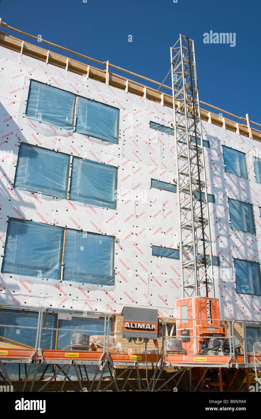 Construction site lift and block of flats wall covered with Paroc Tyvek ...