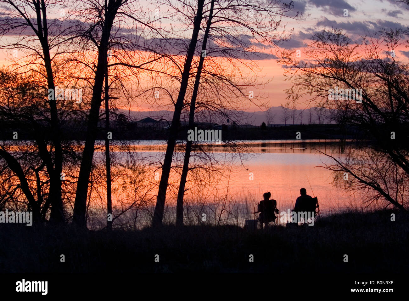 Nightfall sunset mountains lake family couple fishing hi-res stock ...